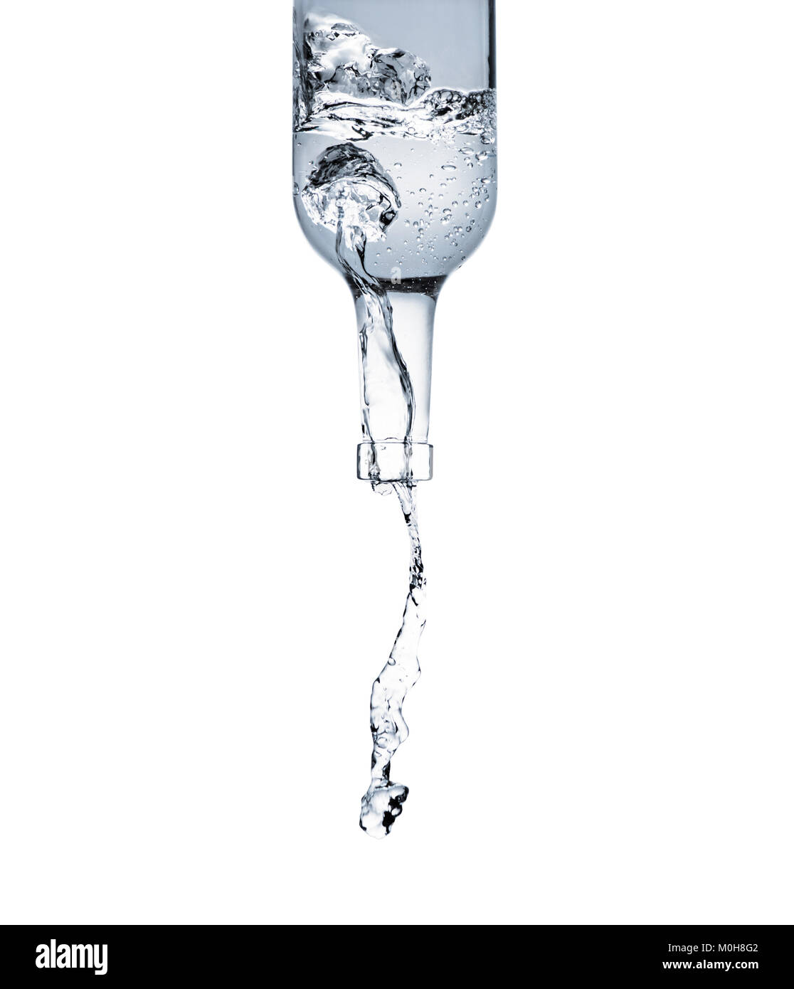 motion shot of water pouring from glass bottle isolated on white Stock ...