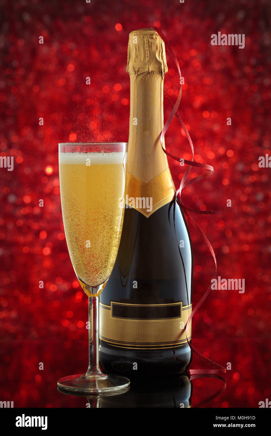 Glass of champagne and red decoration of lights Stock Photo - Alamy