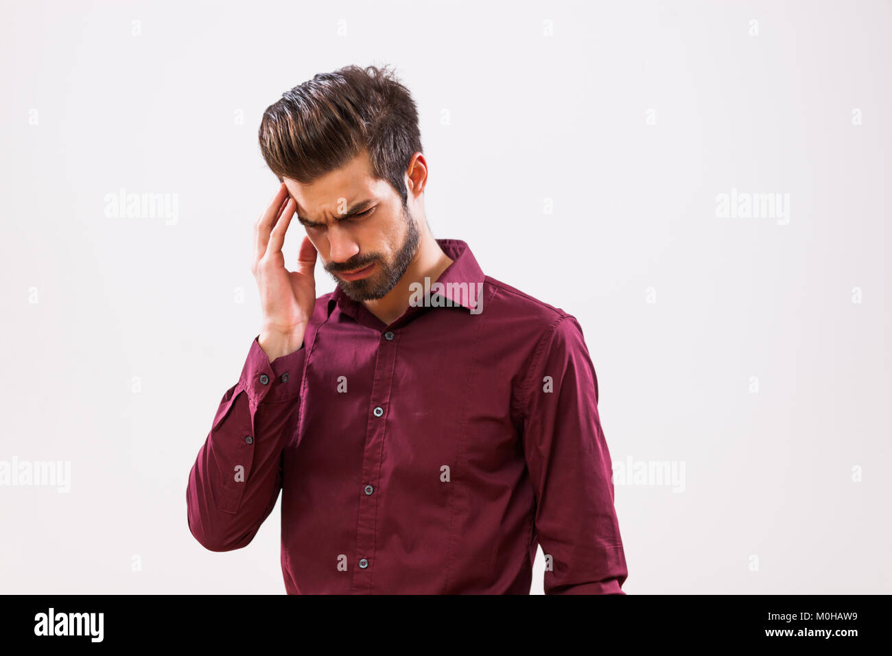 Portrait of young businessman who is having headache Stock Photo - Alamy
