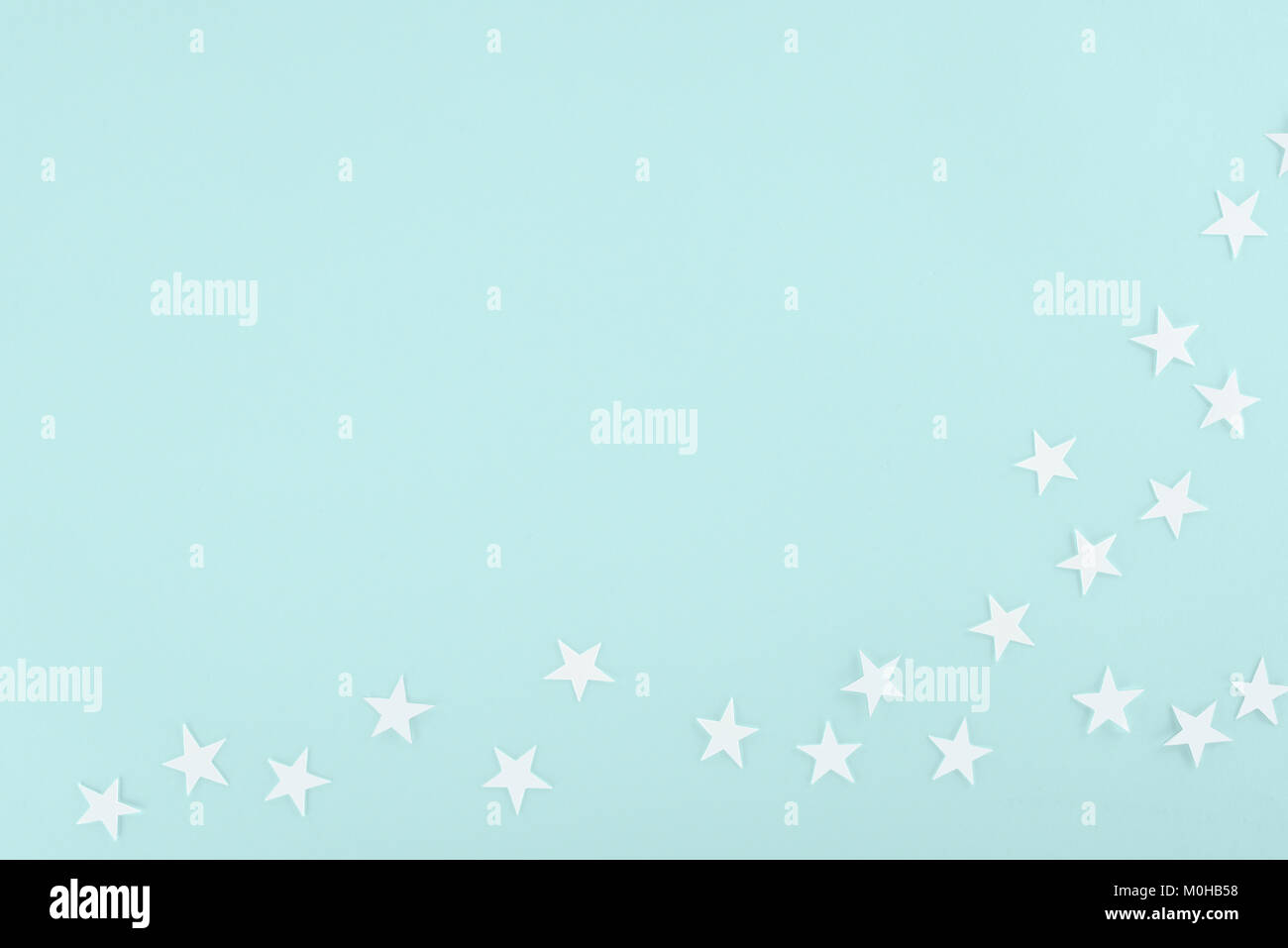background with white paper stars, isolated on light blue Stock Photo ...