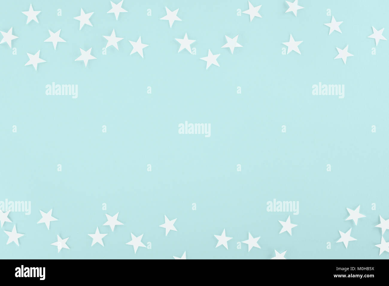 background with white paper stars, isolated on light blue Stock Photo ...