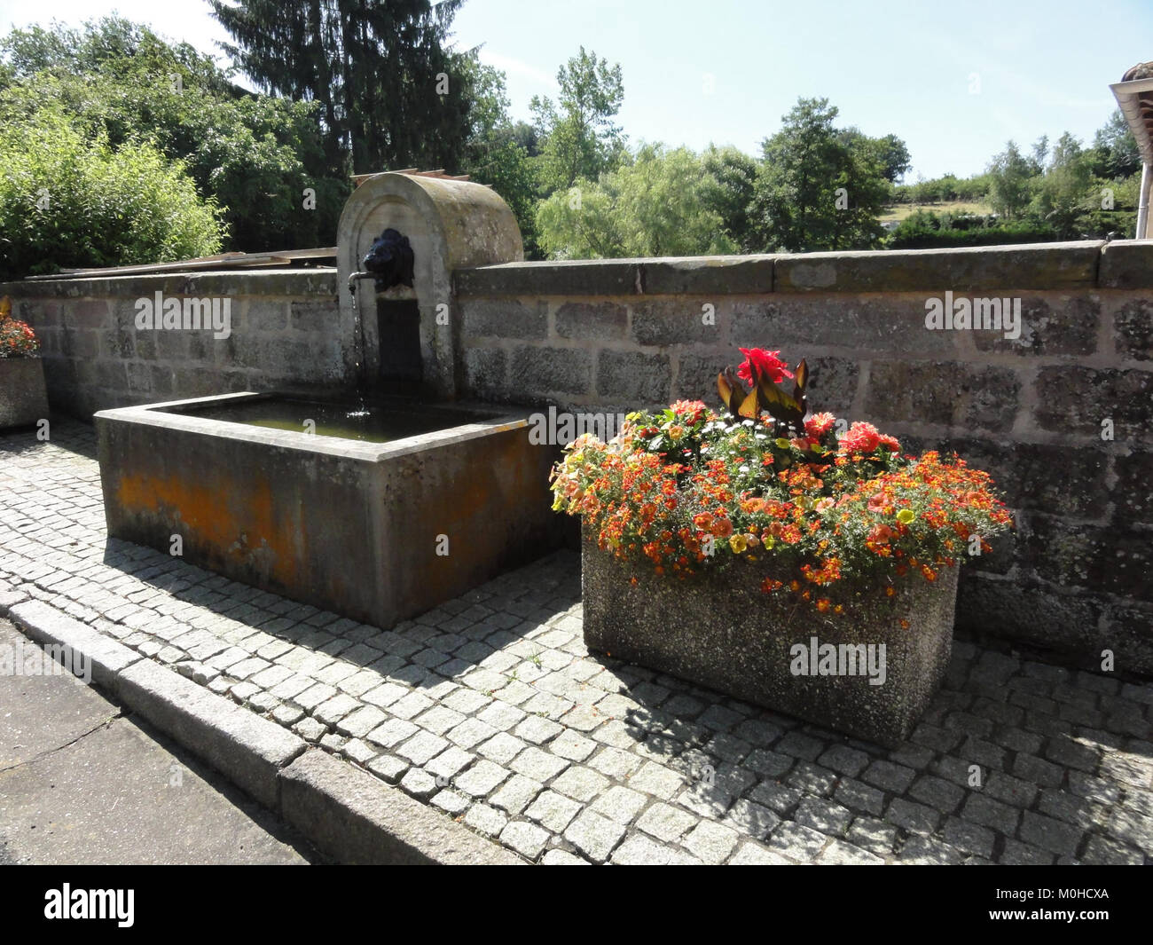 The stone public fountain in the village of Bréménil, Meurthe-et ...