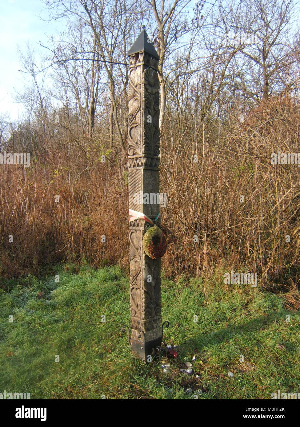 This image shows a kopjafa, a traditional Hungarian wooden memorial ...