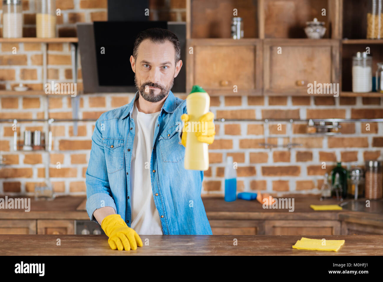 Mysterious male cleaner stretching cleanser Stock Photo - Alamy