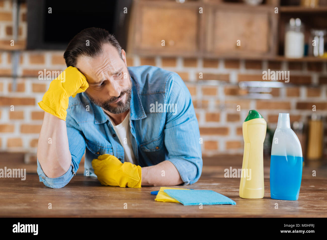 Thoughtful male cleaner facing problem Stock Photo - Alamy