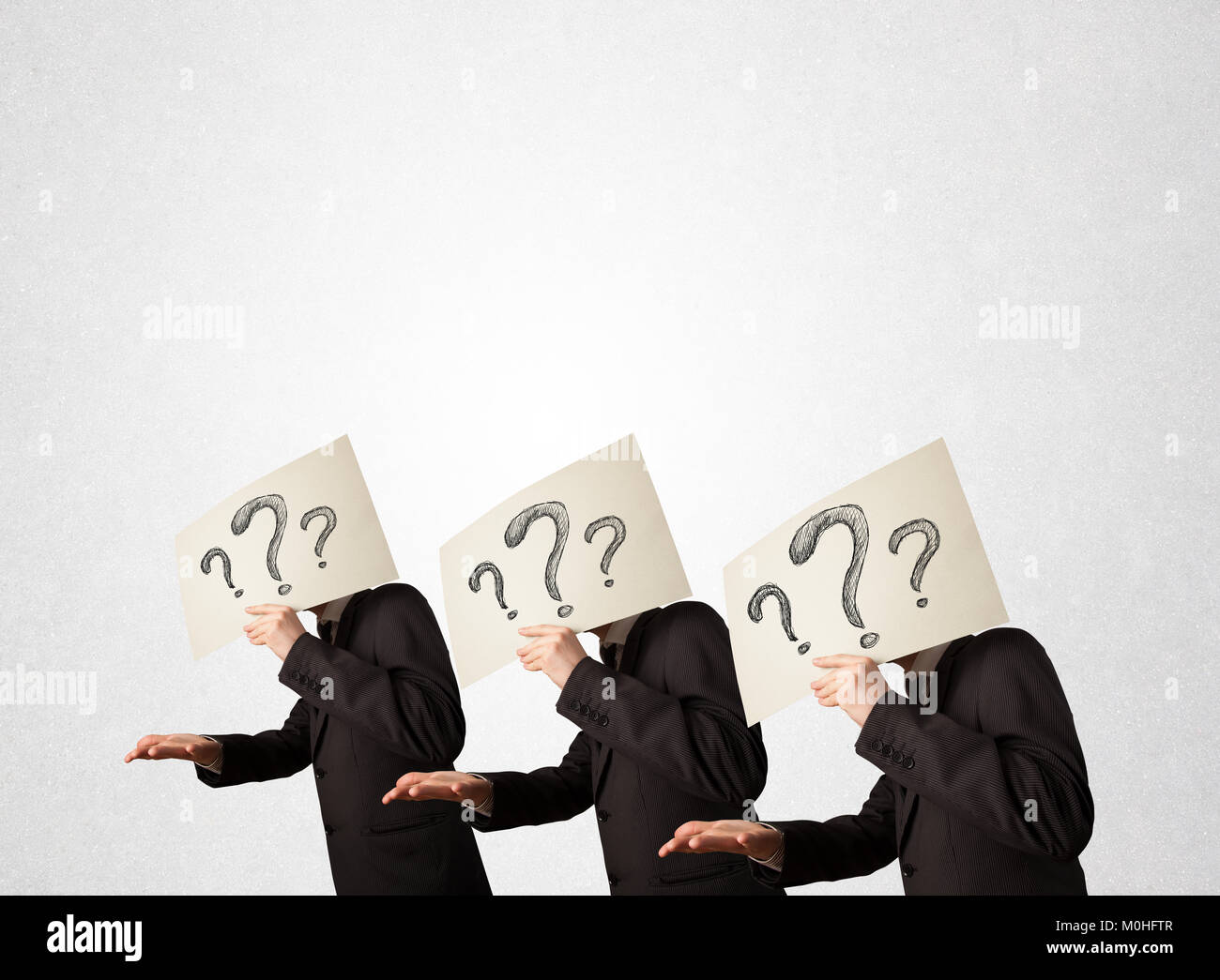 Handsome people in formal gesturing with drawn question marks on ...