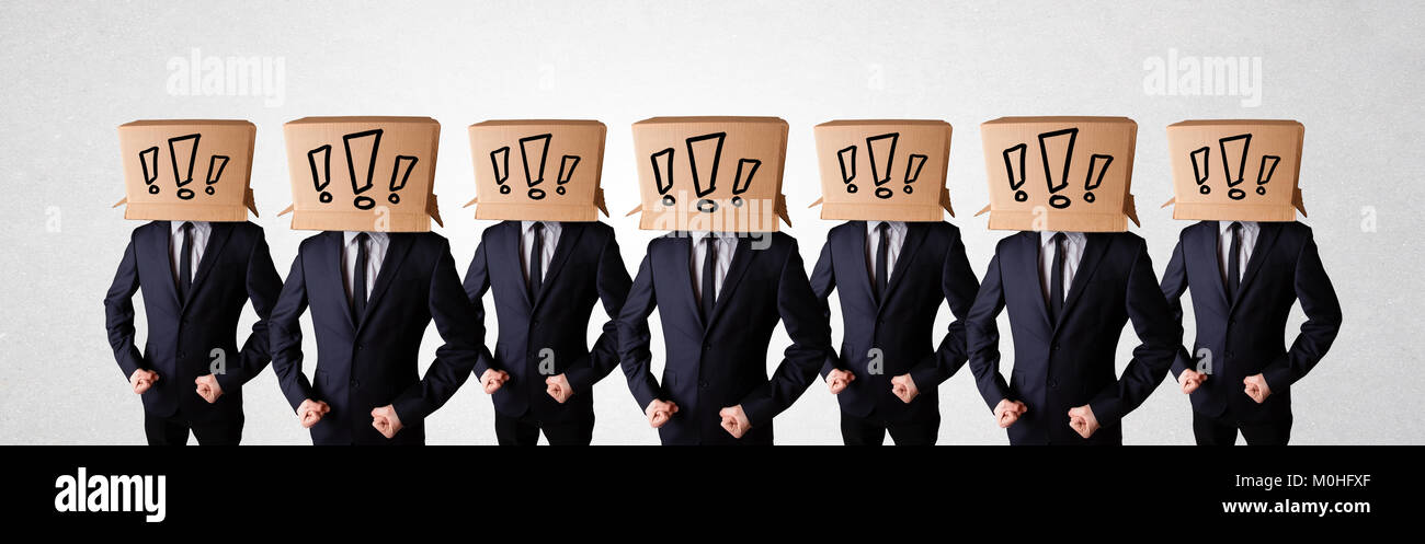 Group of men gesturing with exclamation marks drawn on box on their ...