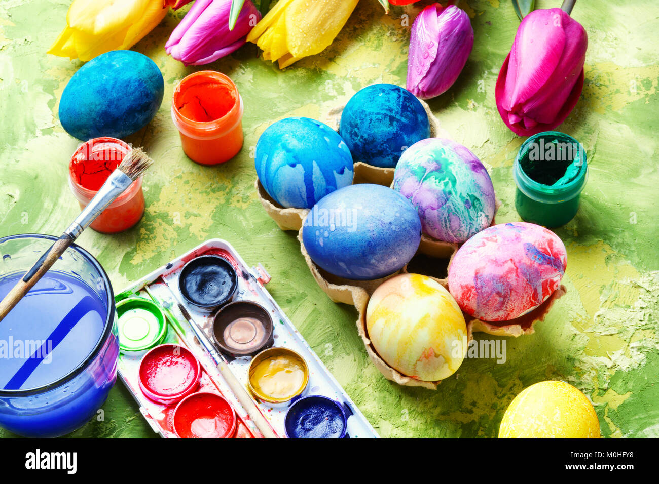 symbolic Easter colored egg and colorful paint Stock Photo - Alamy