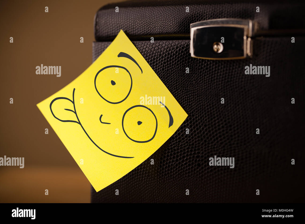 Drawn smiley face on a post-it note sticked on a jewelry box Stock ...