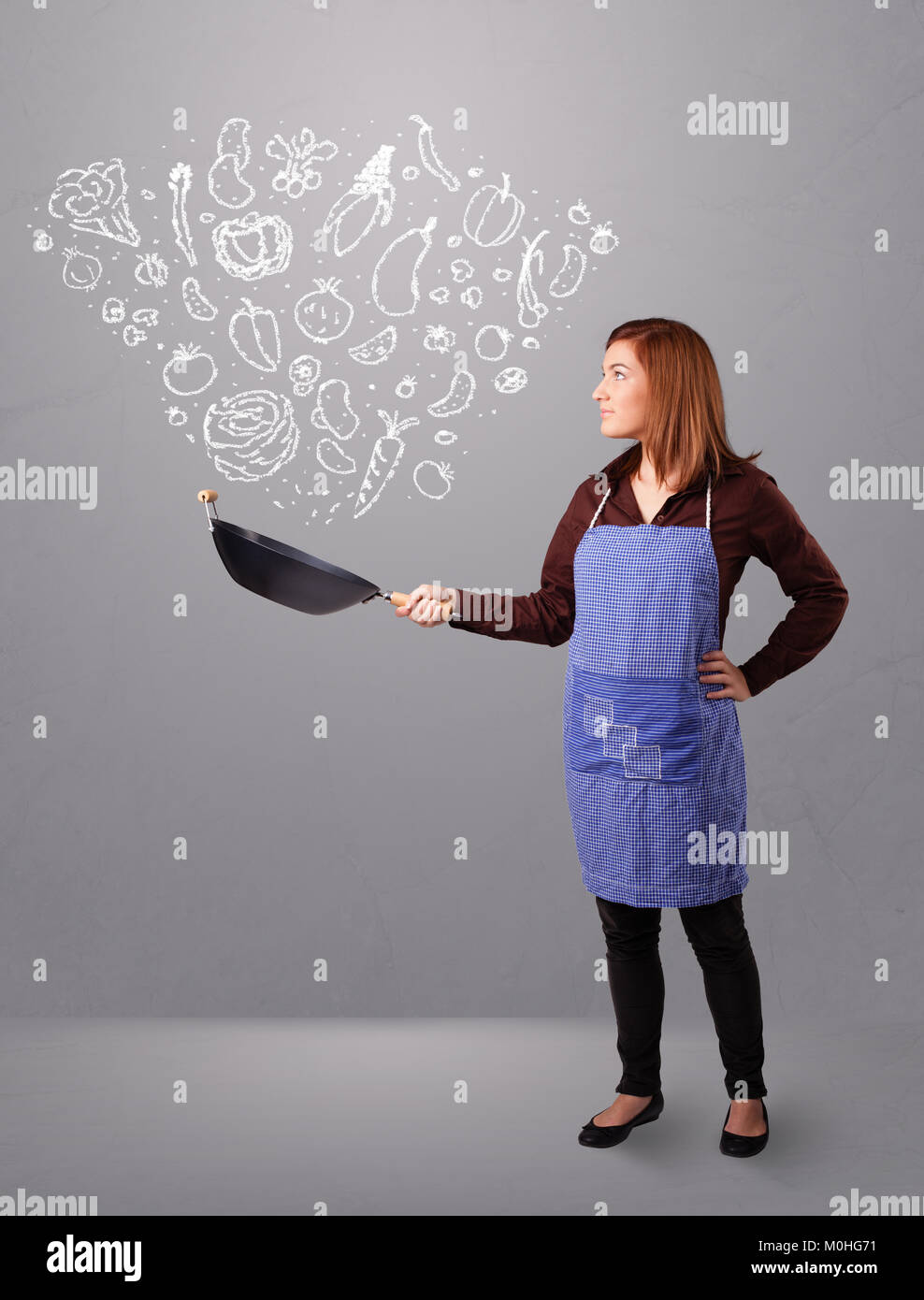Pretty lady cooking vegetables Stock Photo - Alamy