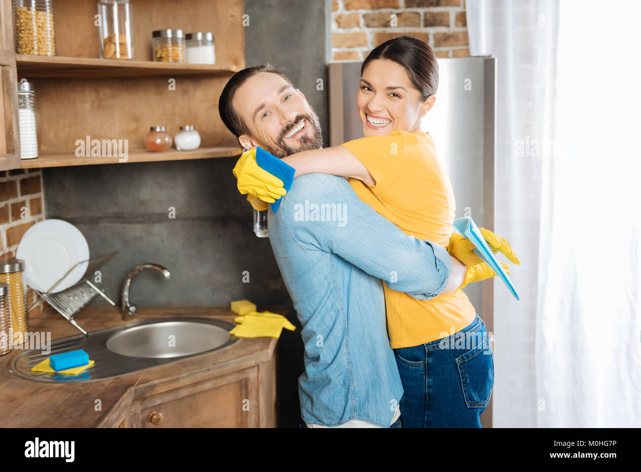 Appealing joyful couple cleaning together Stock Photo - Alamy