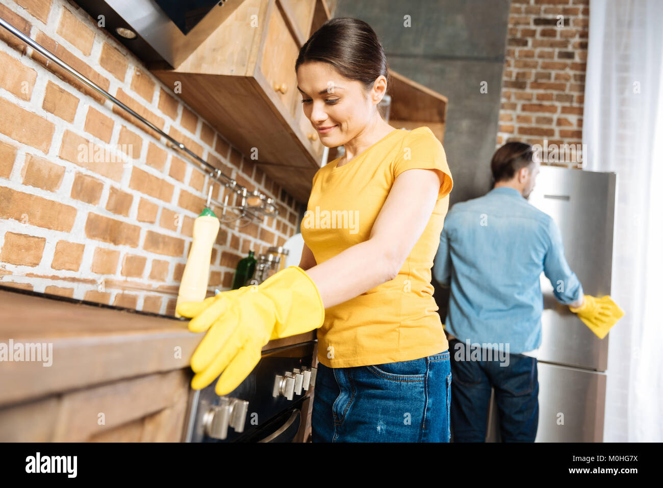 Pleasant concentrated wife helping husband Stock Photo - Alamy