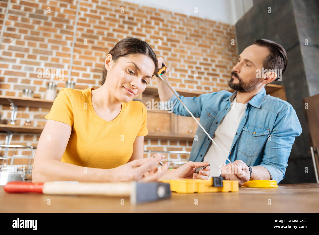 Sweet cute couple fixing shelf Stock Photo - Alamy