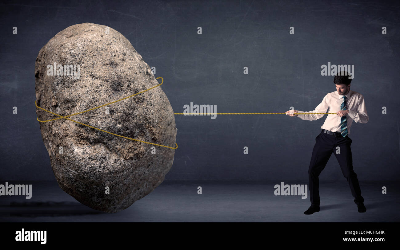 Businessman pulling huge rock with a rope concept on background Stock ...