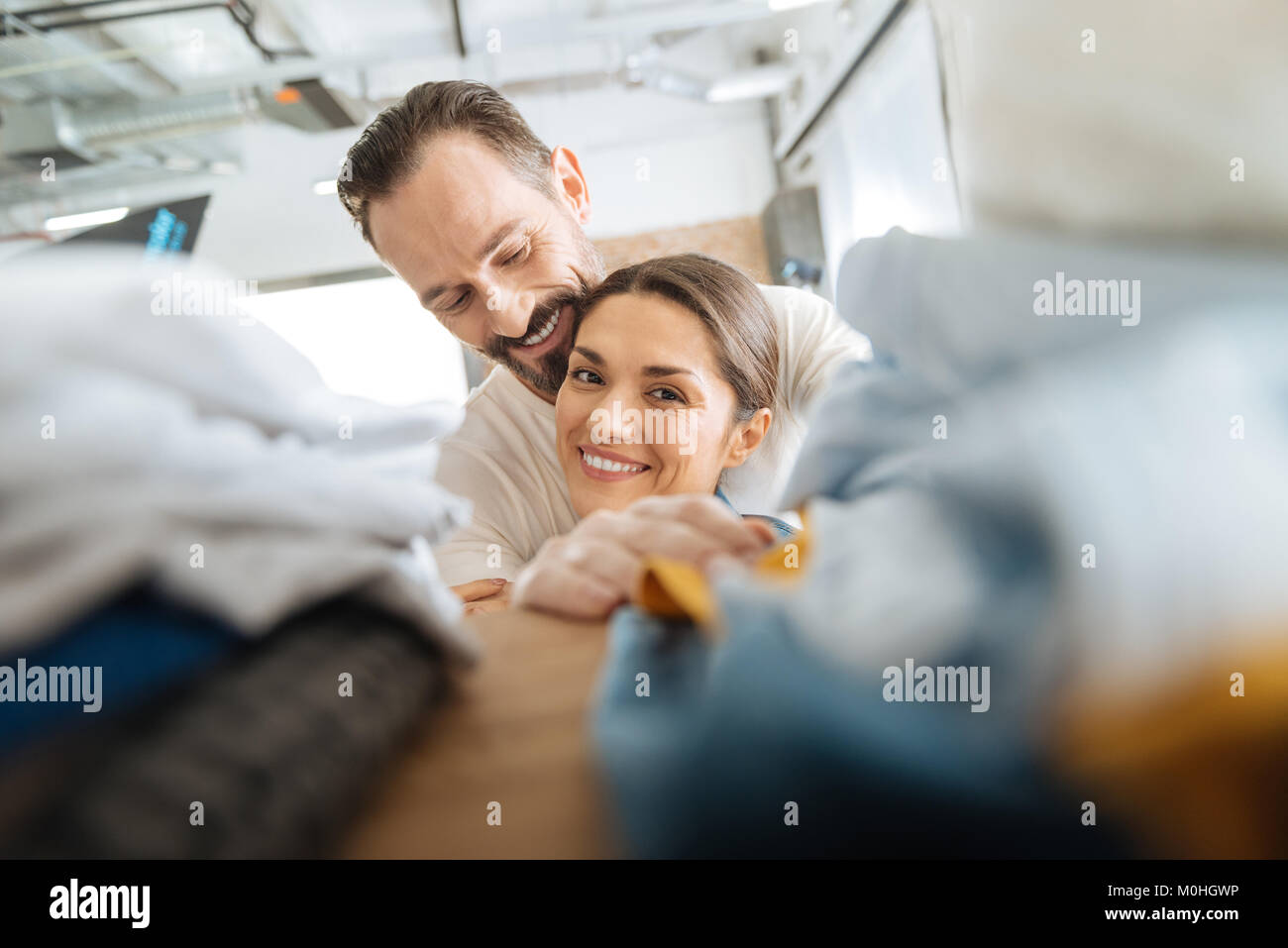 Joyful energetic couple distracting from laundry Stock Photo - Alamy