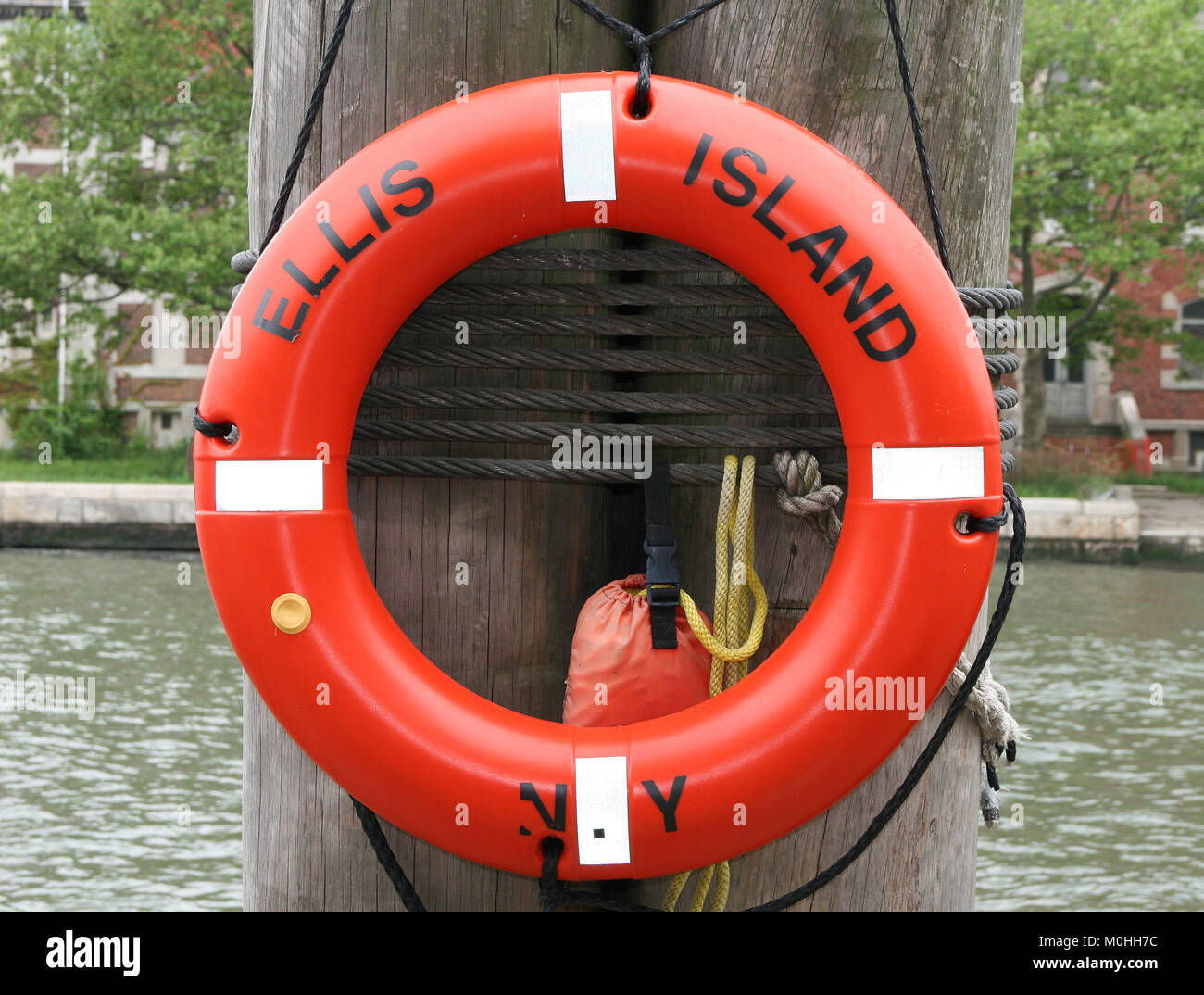 Red ring life float on wooden pier harbour poles at the harbour of ...
