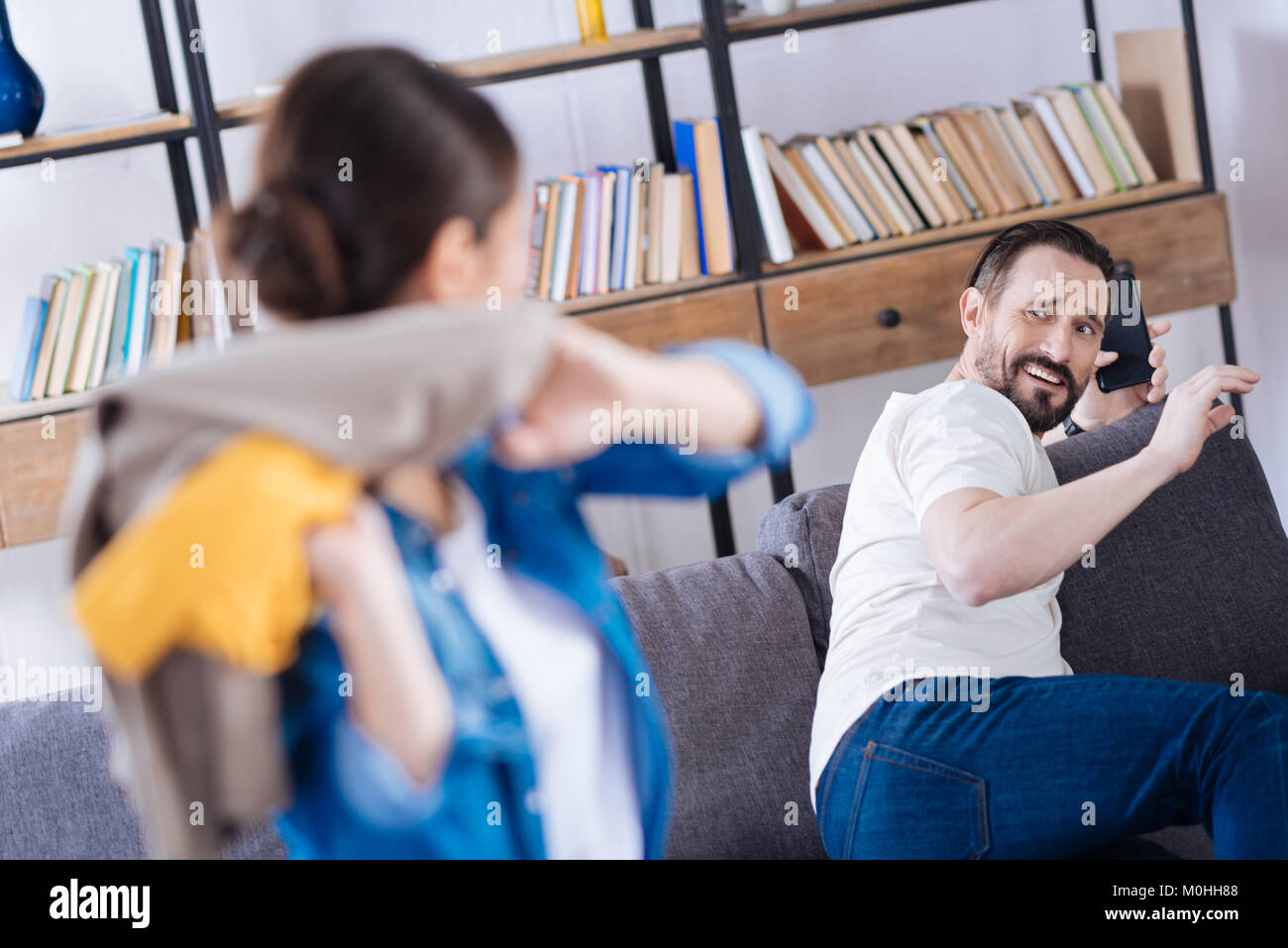 Scared handsome husband making wife angry Stock Photo - Alamy