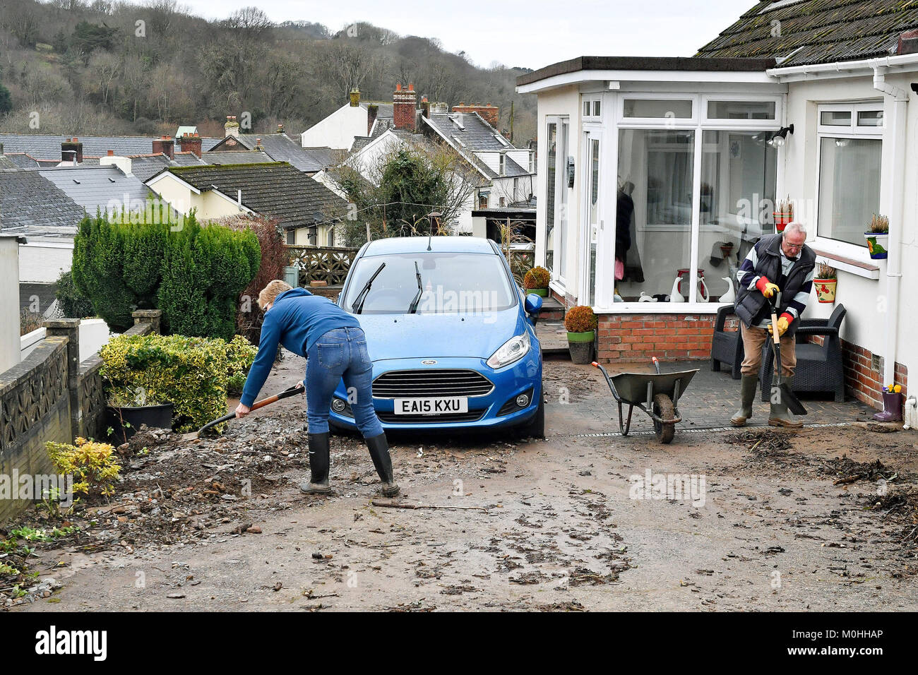 Paul and Lucy Davis clear silt and debris from their home on Corner ...