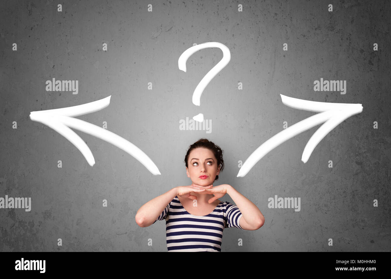 Pretty young woman making a decision with arrows and question mark ...