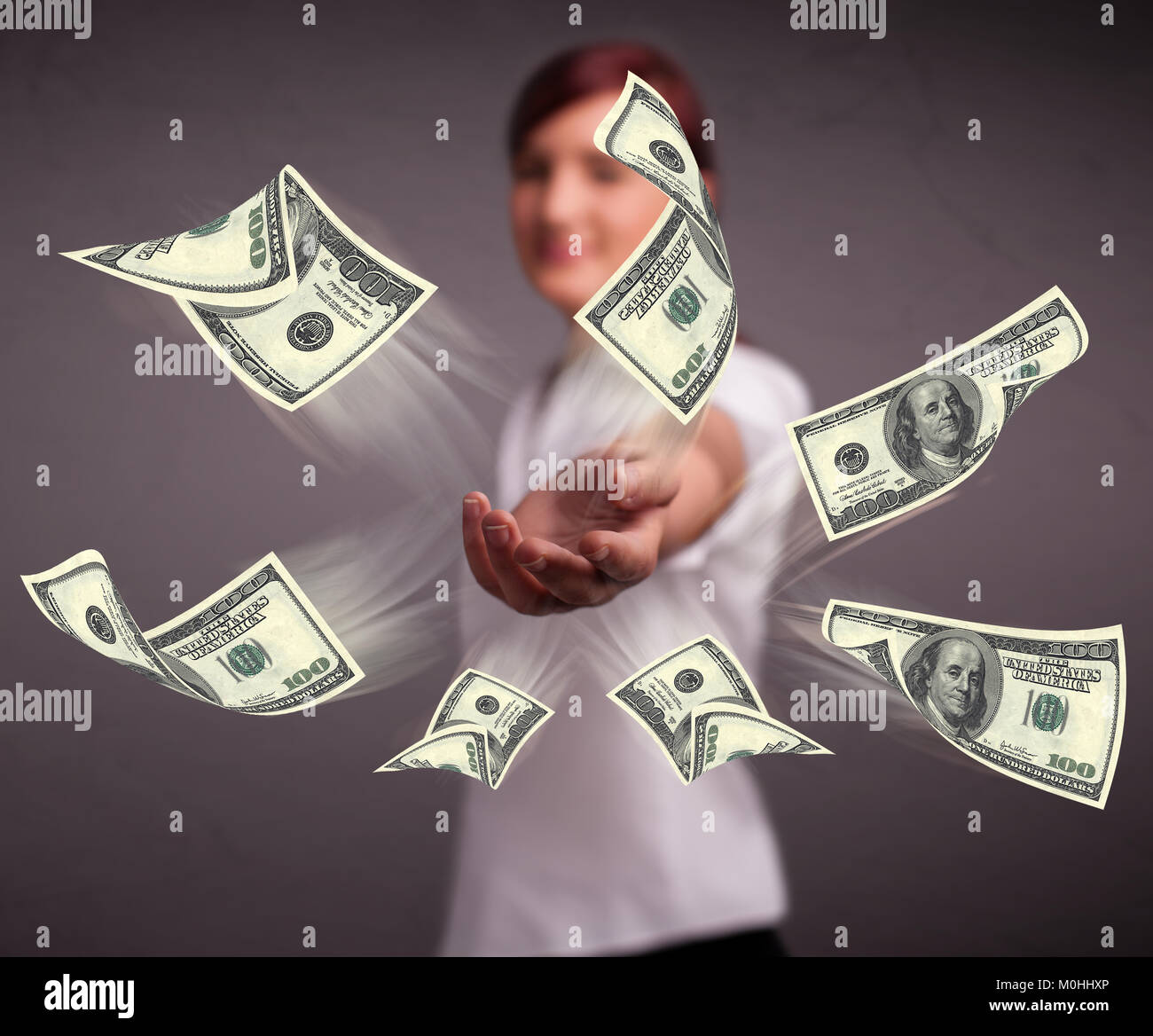 Beautiful young girl throwing money Stock Photo - Alamy
