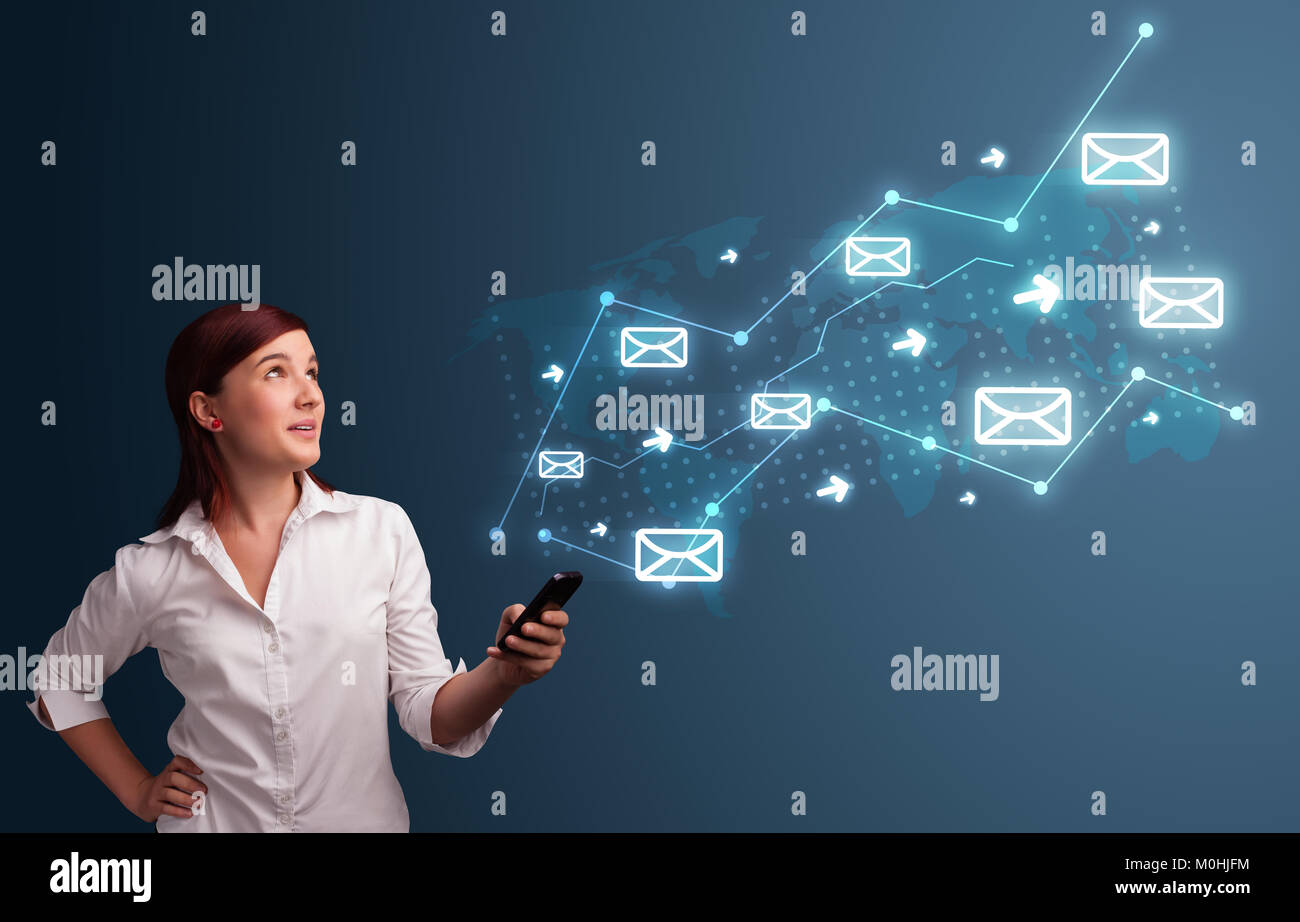 Attractive young lady standing and holding a phone with arrows and ...