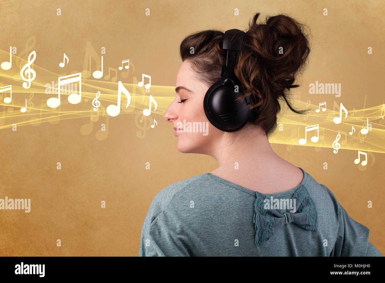 Pretty young woman listening to music, notes concept Stock Photo - Alamy