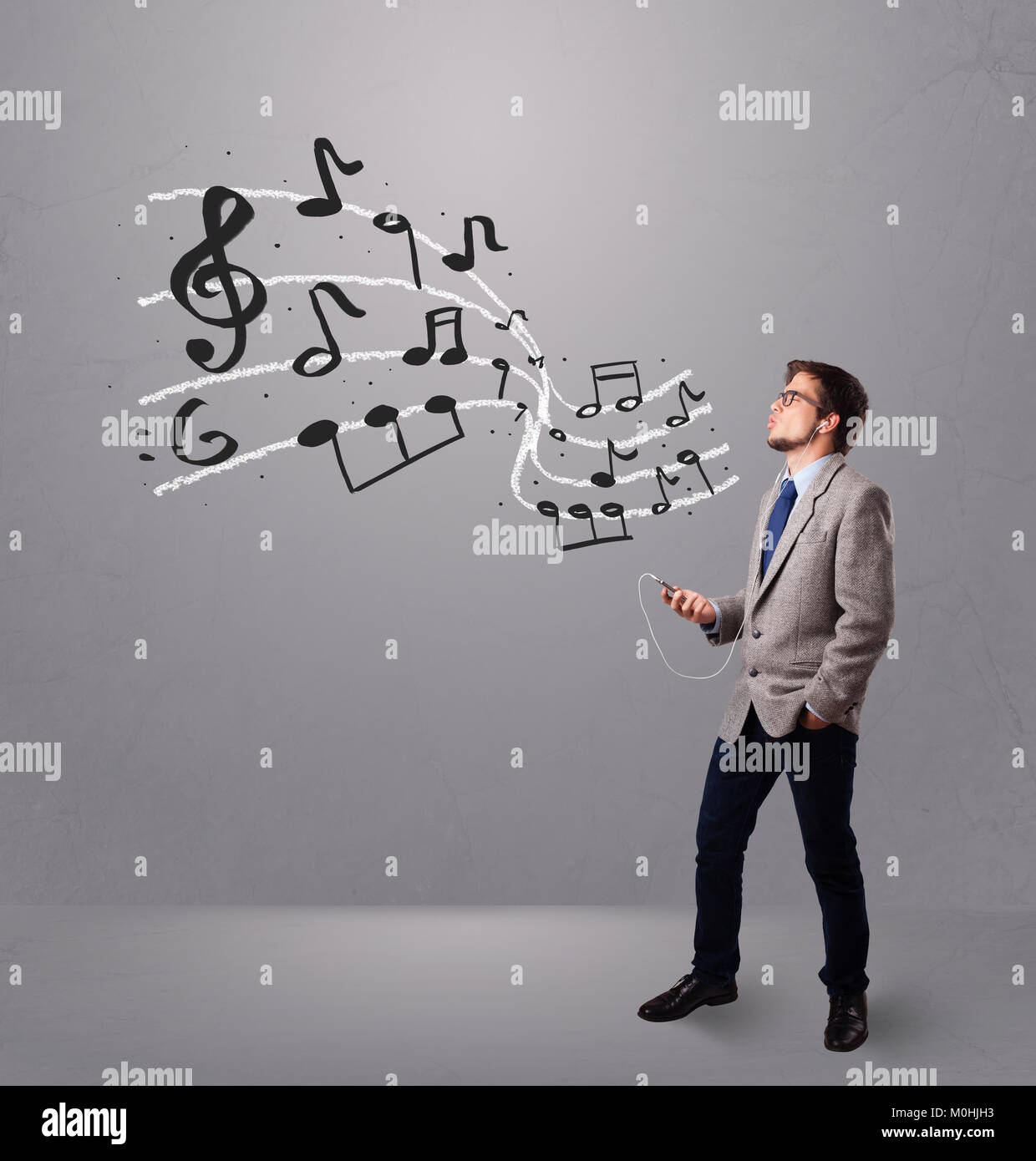 handsome boy singing and listening to music with musical notes getting ...