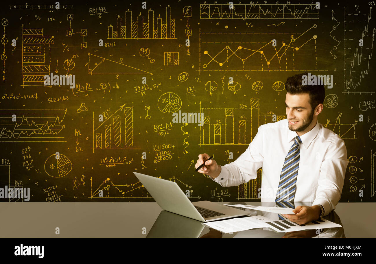 Businessman sitting at black table with hand drawn diagram background ...