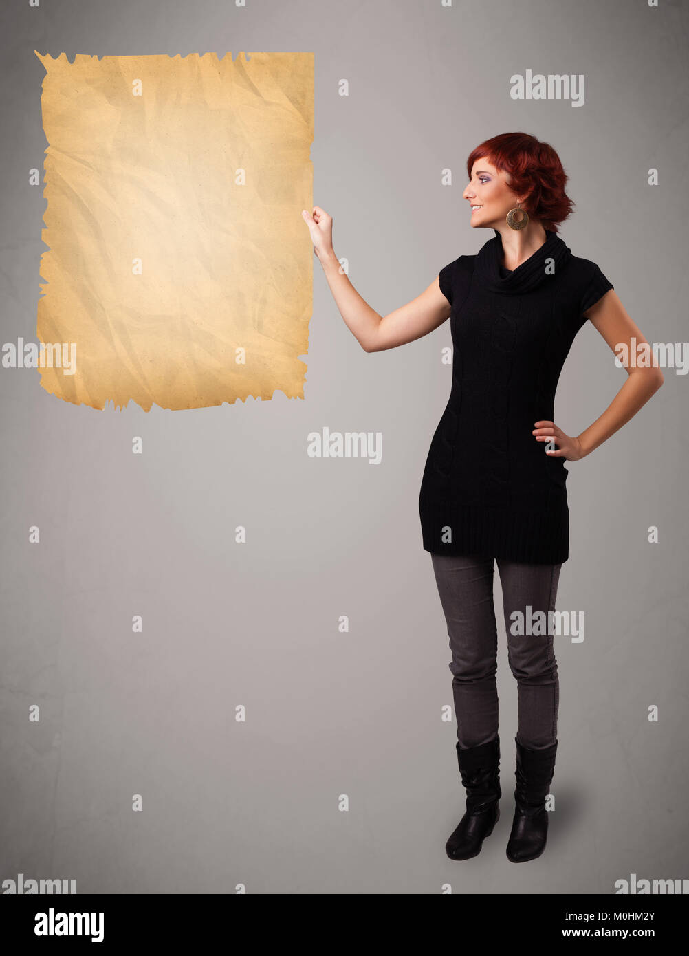 Beautiful young girl presenting old paper copy space Stock Photo - Alamy