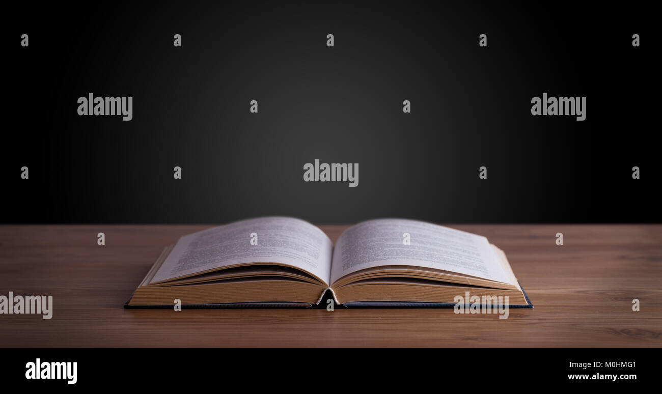 Open book on wooden deck and copy space Stock Photo - Alamy