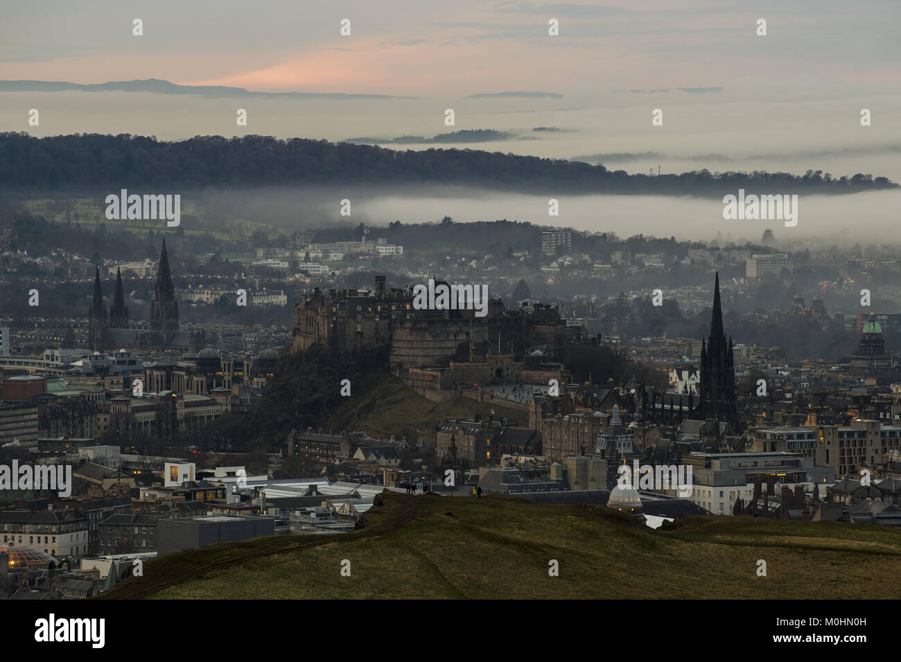 A thick mist rolls over Edinburgh city centre as shoppers crowd the ...