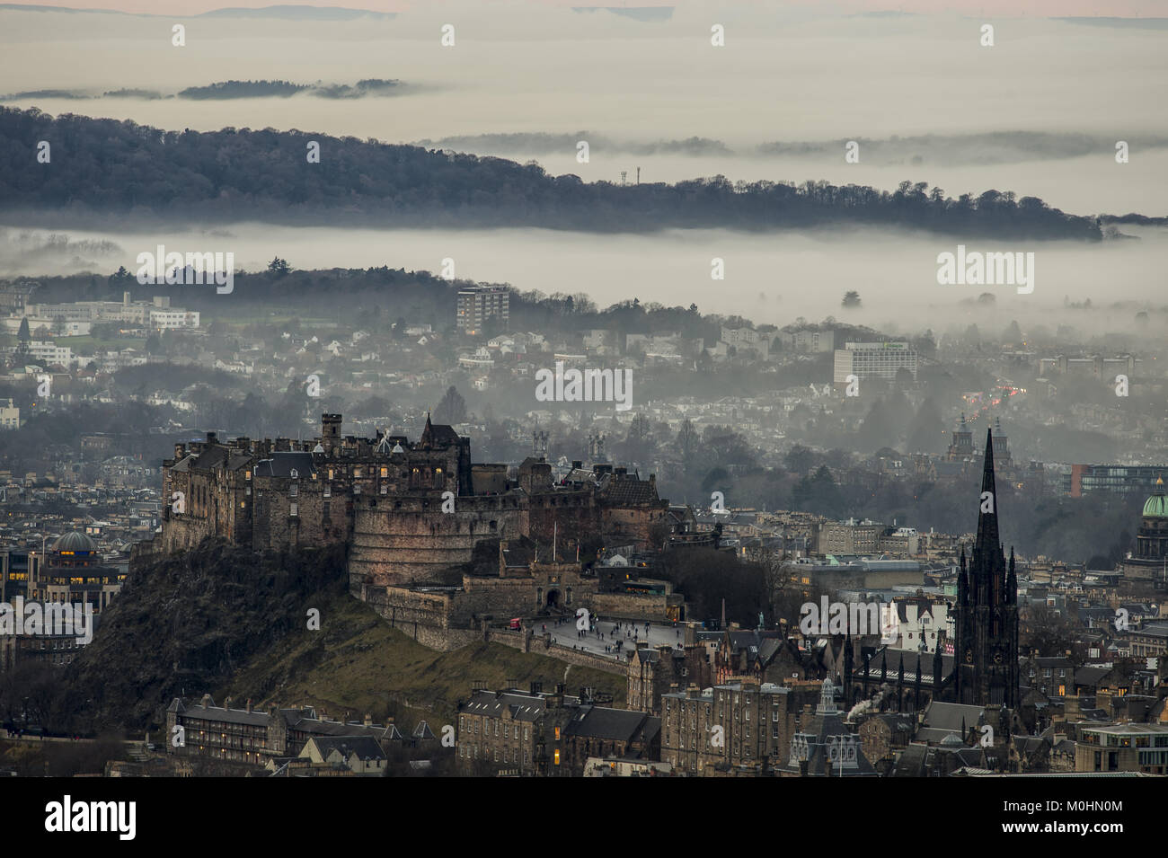 A thick mist rolls over Edinburgh city centre as shoppers crowd the ...