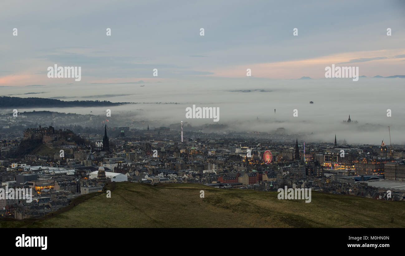 A thick mist rolls over Edinburgh city centre as shoppers crowd the ...