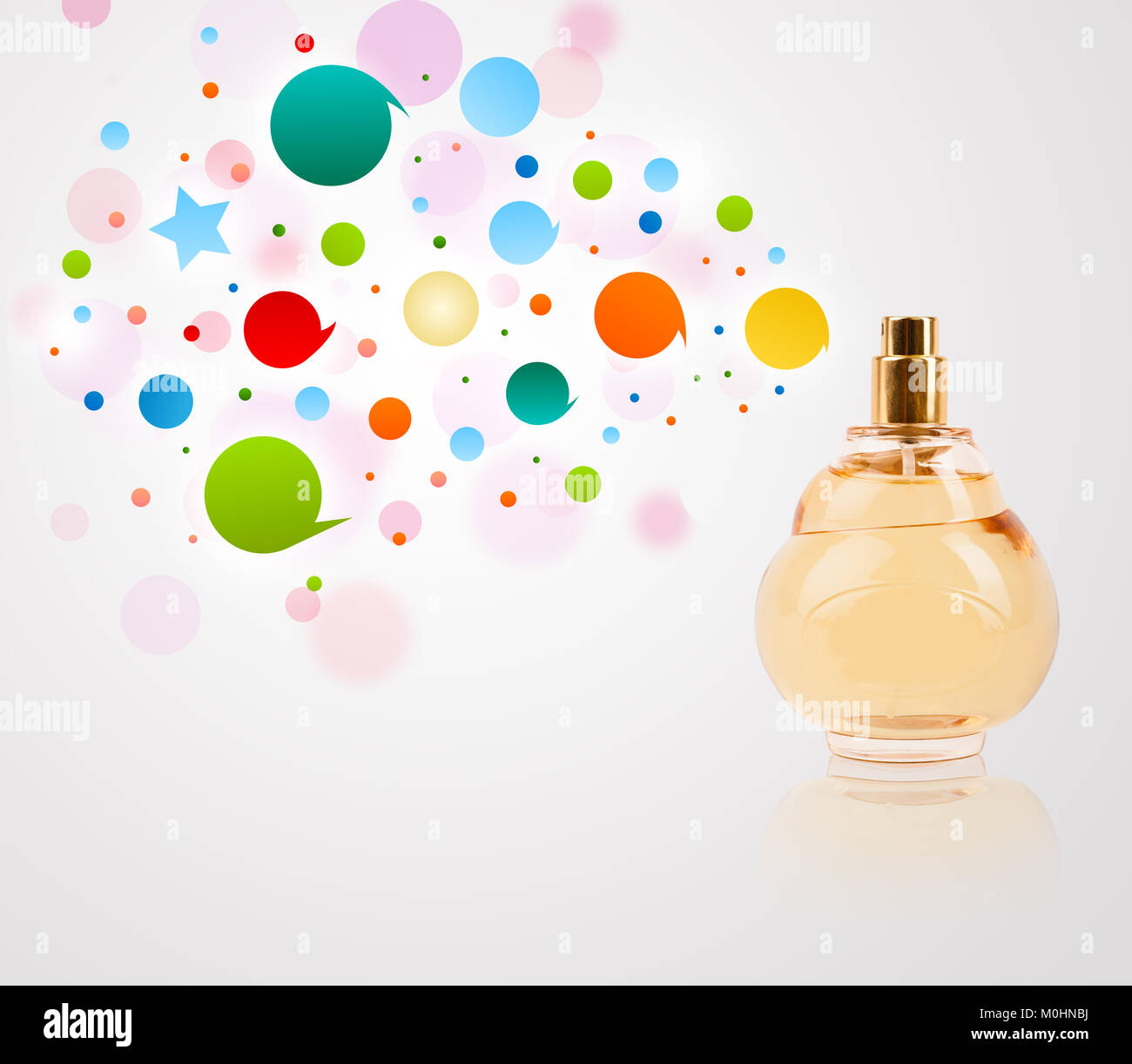 Perfume bottle spraying colorful bubbles Stock Photo - Alamy