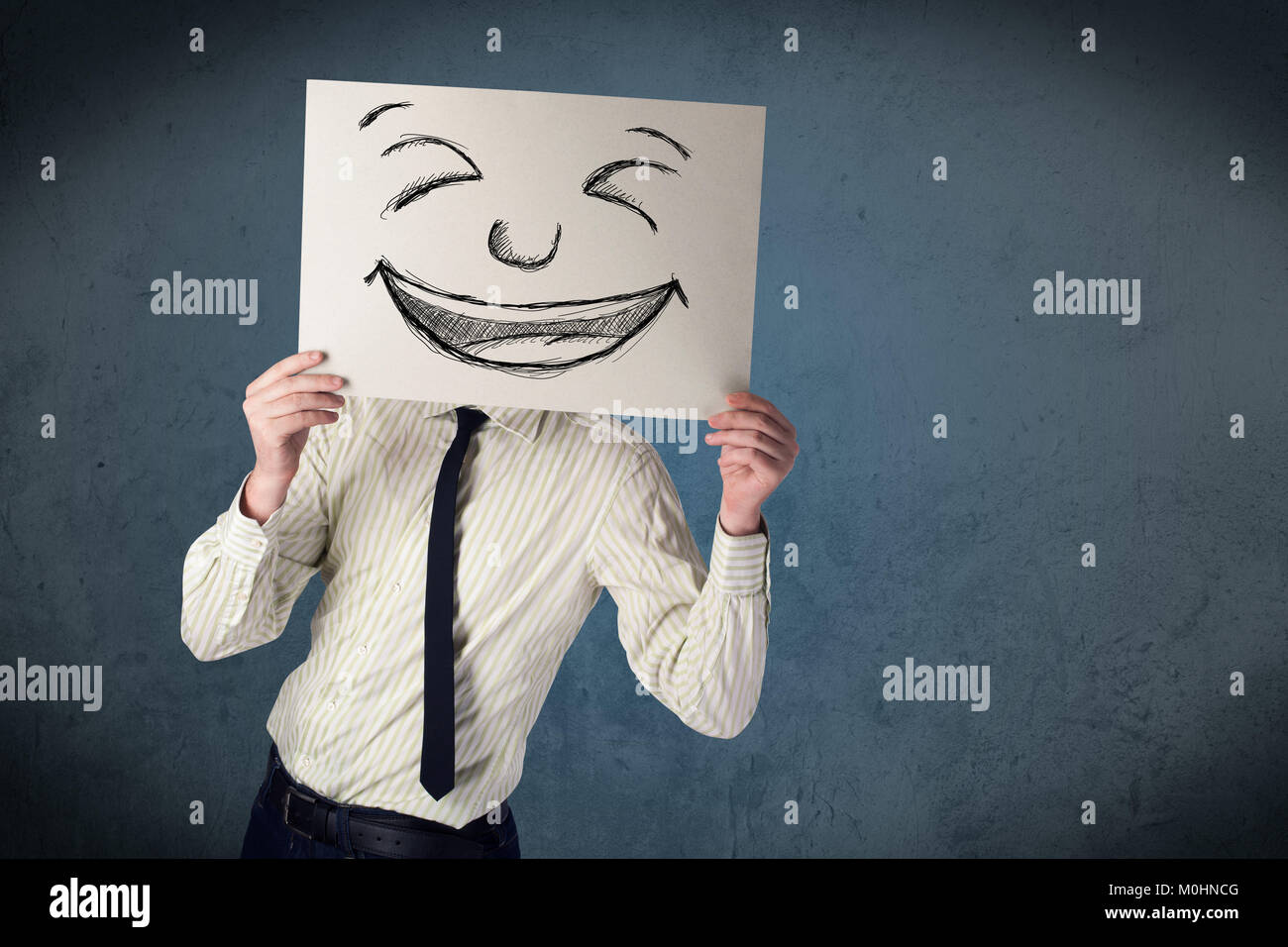 Businessman holding cardboard smiley face hi-res stock photography and ...