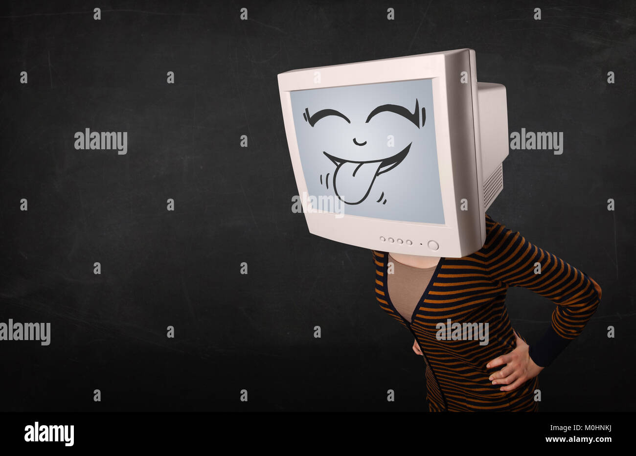 Young girl wearing a monitor with a funny face gesture Stock Photo - Alamy