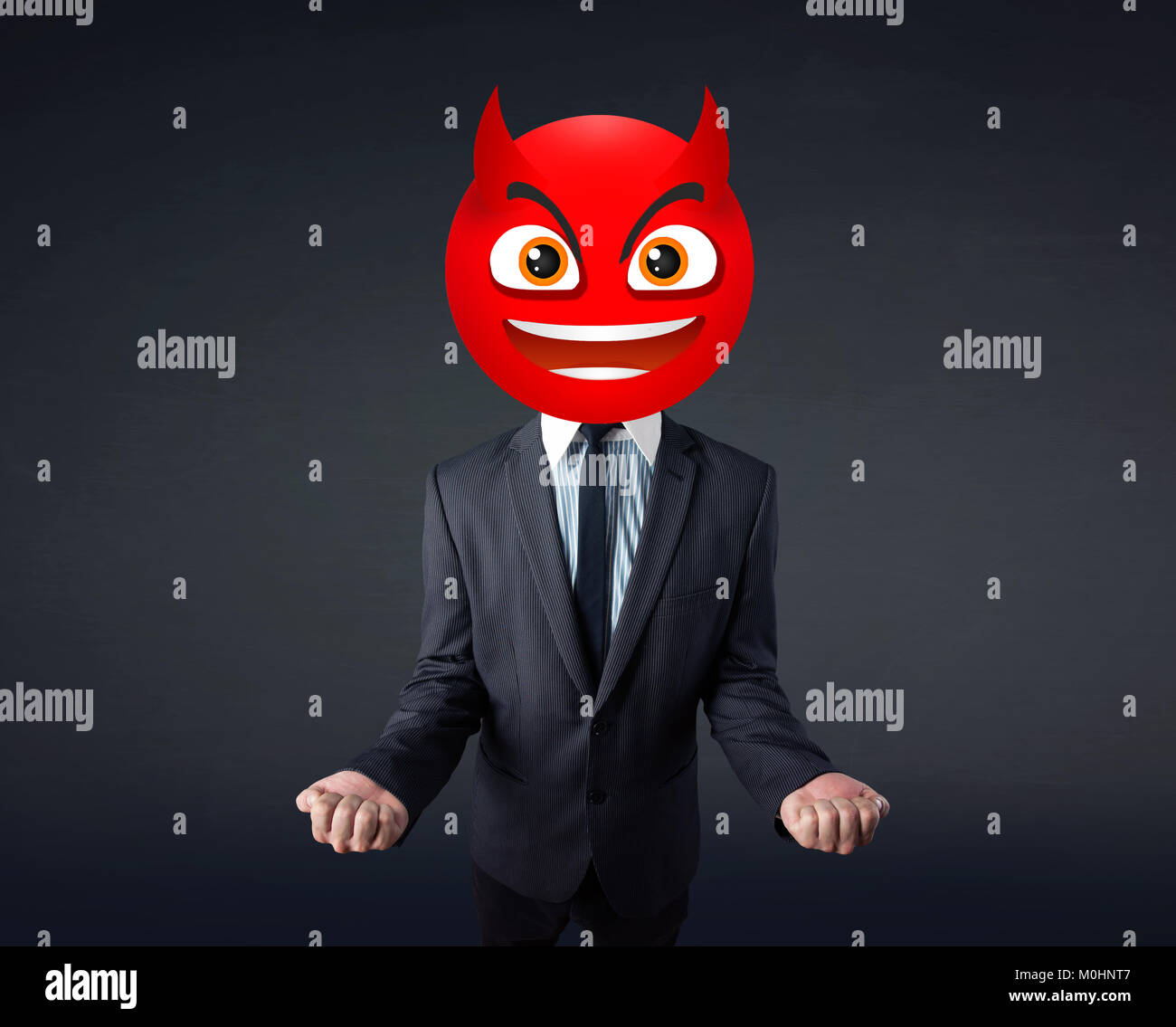 Funny businessman wears devil smiley face Stock Photo - Alamy