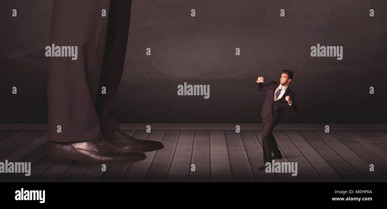 Big person with small businessman concept on background Stock Photo - Alamy