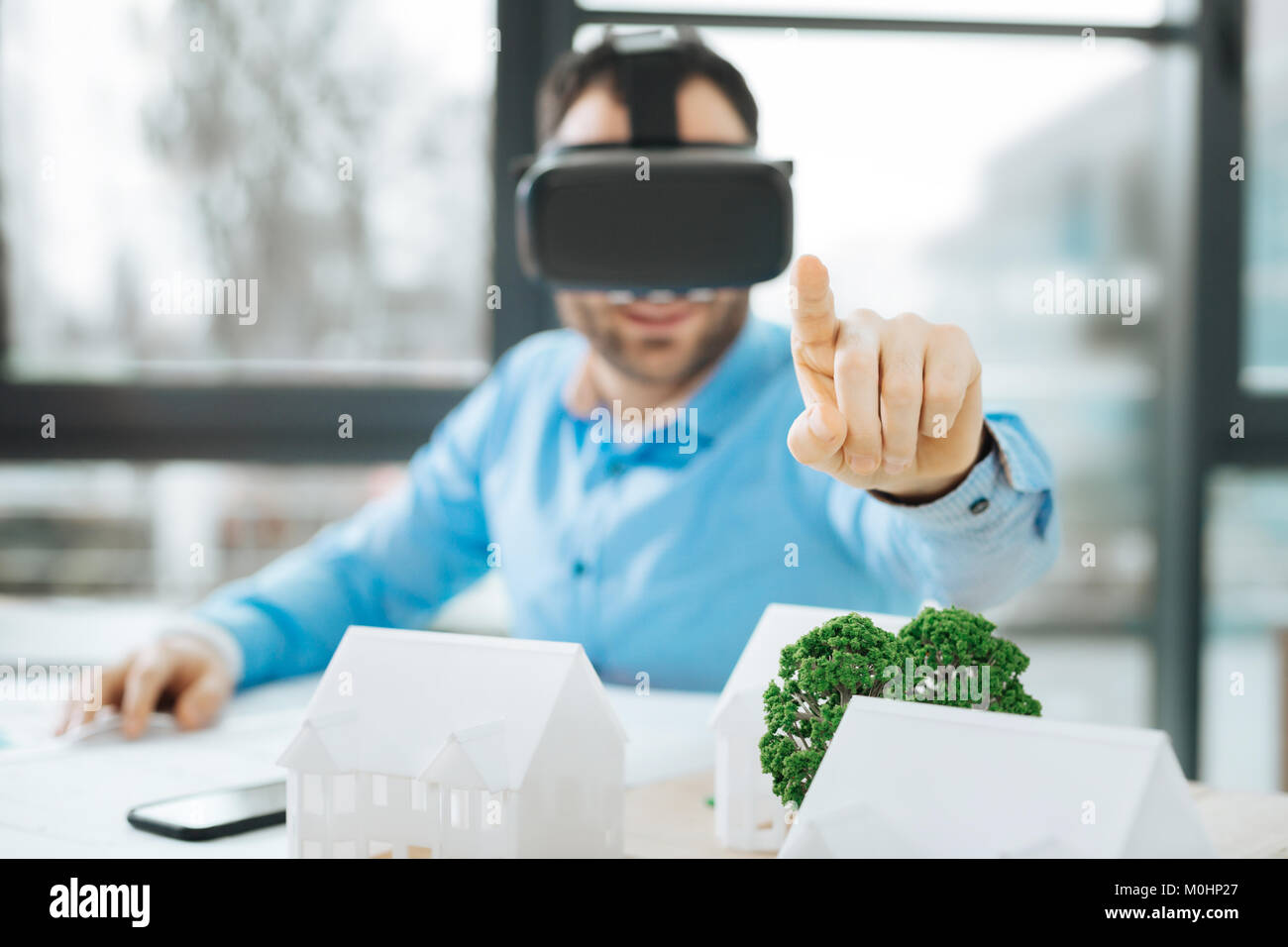 Pleasant architect touching object in virtual reality Stock Photo - Alamy