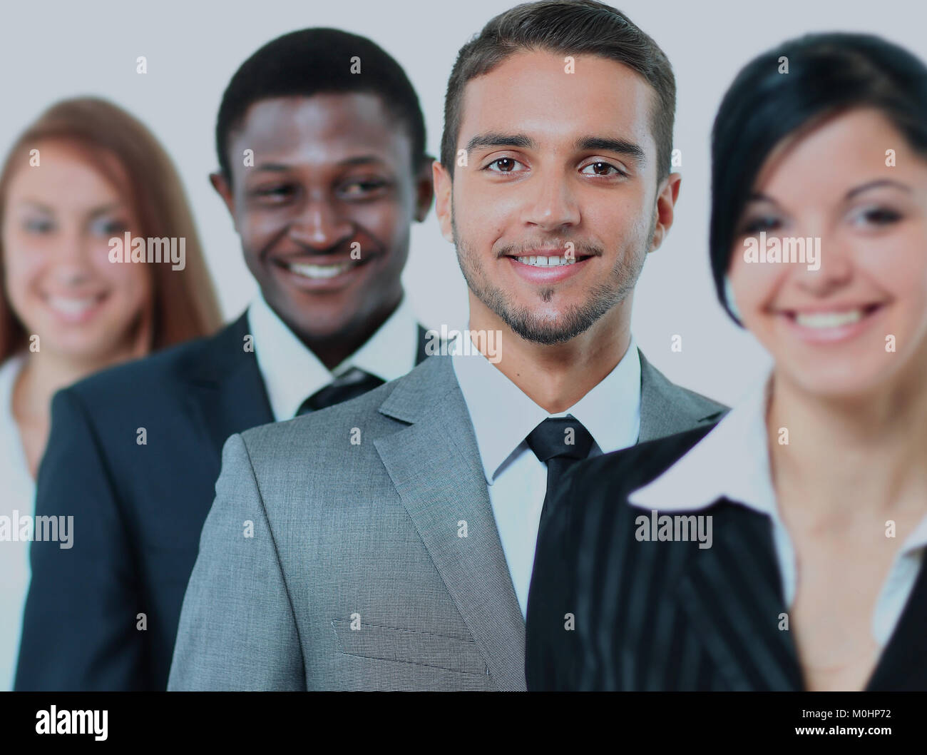 Happy smiling business team standing in a row Stock Photo - Alamy