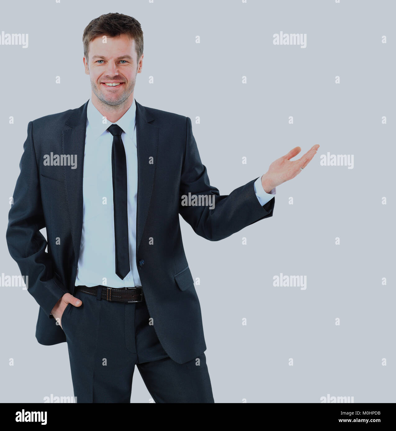 Happy business man presenting and showing on copy space Stock Photo - Alamy