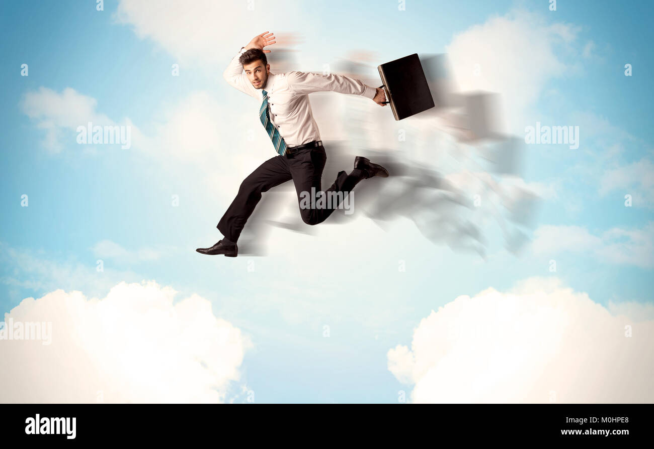 Business person jumping over clouds in the blue sky concept Stock Photo ...