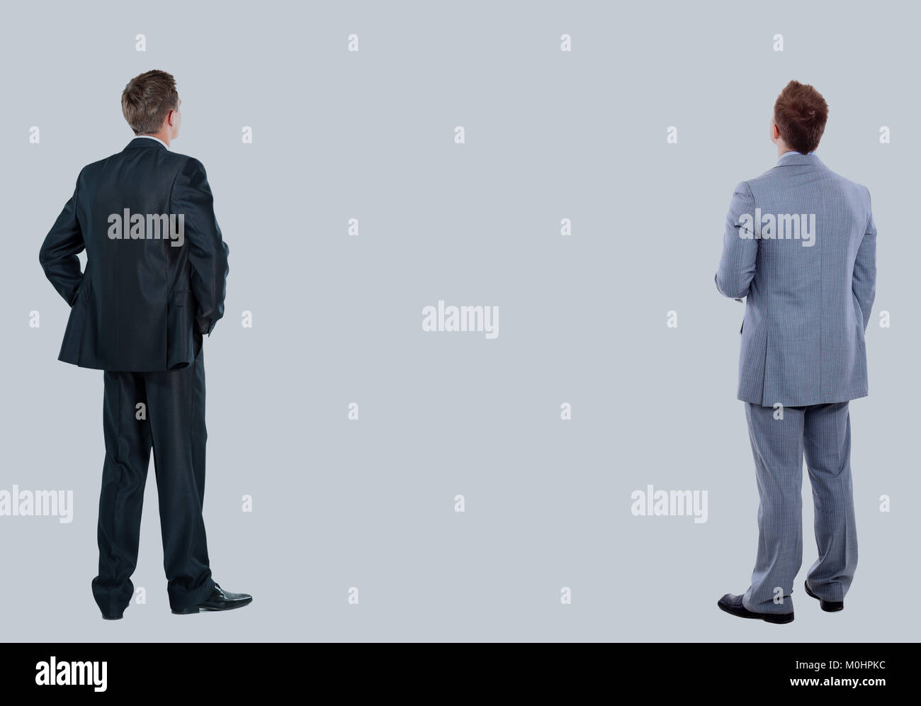 two business mans from the back - looking at something over a white ...