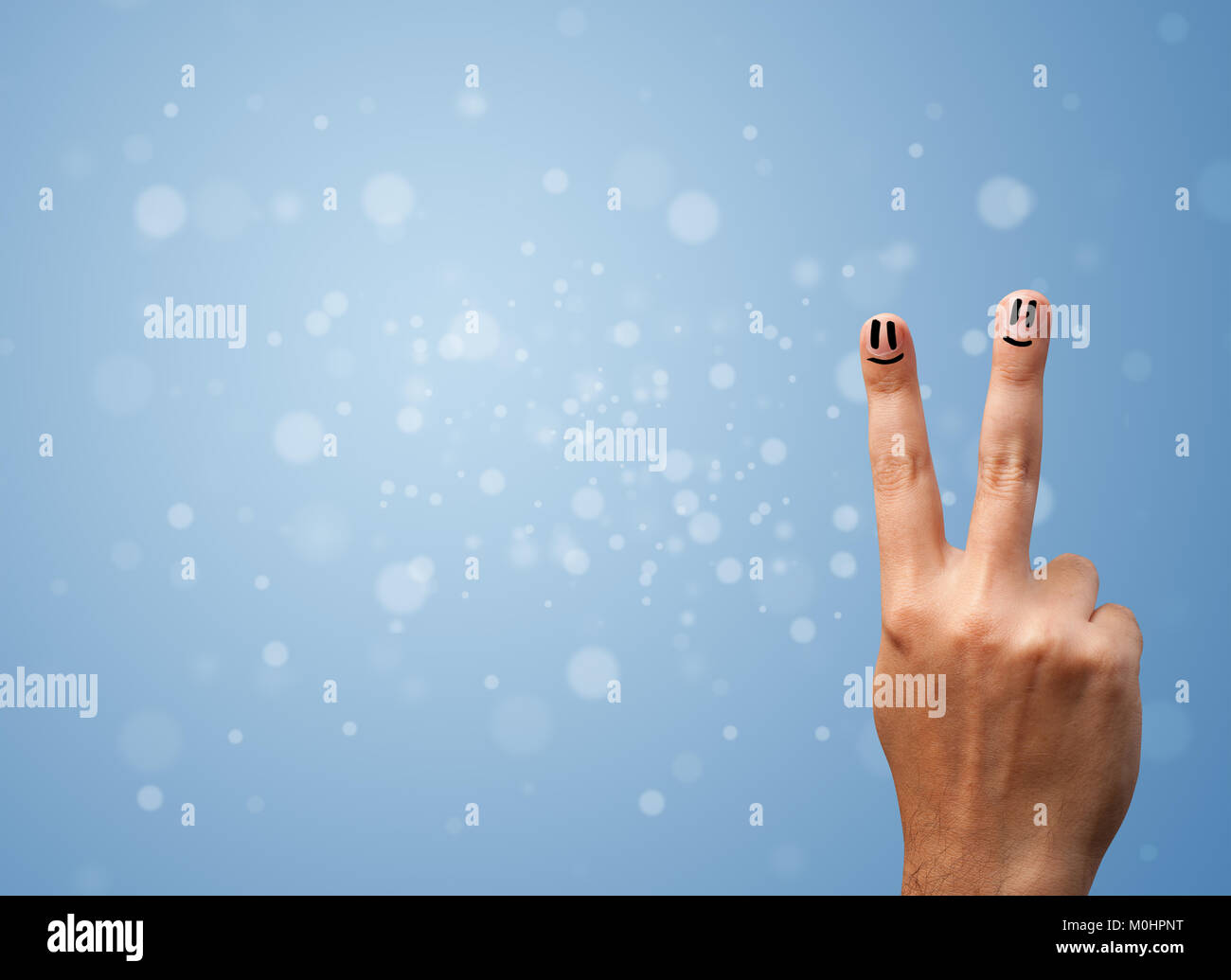 Happy finger smileys faces on hand with empty blue bokeh background ...