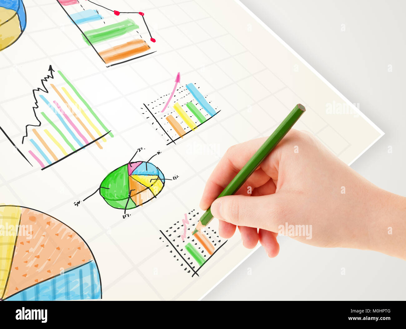 Business person drawing colorful graphs and icons on plain paper Stock ...