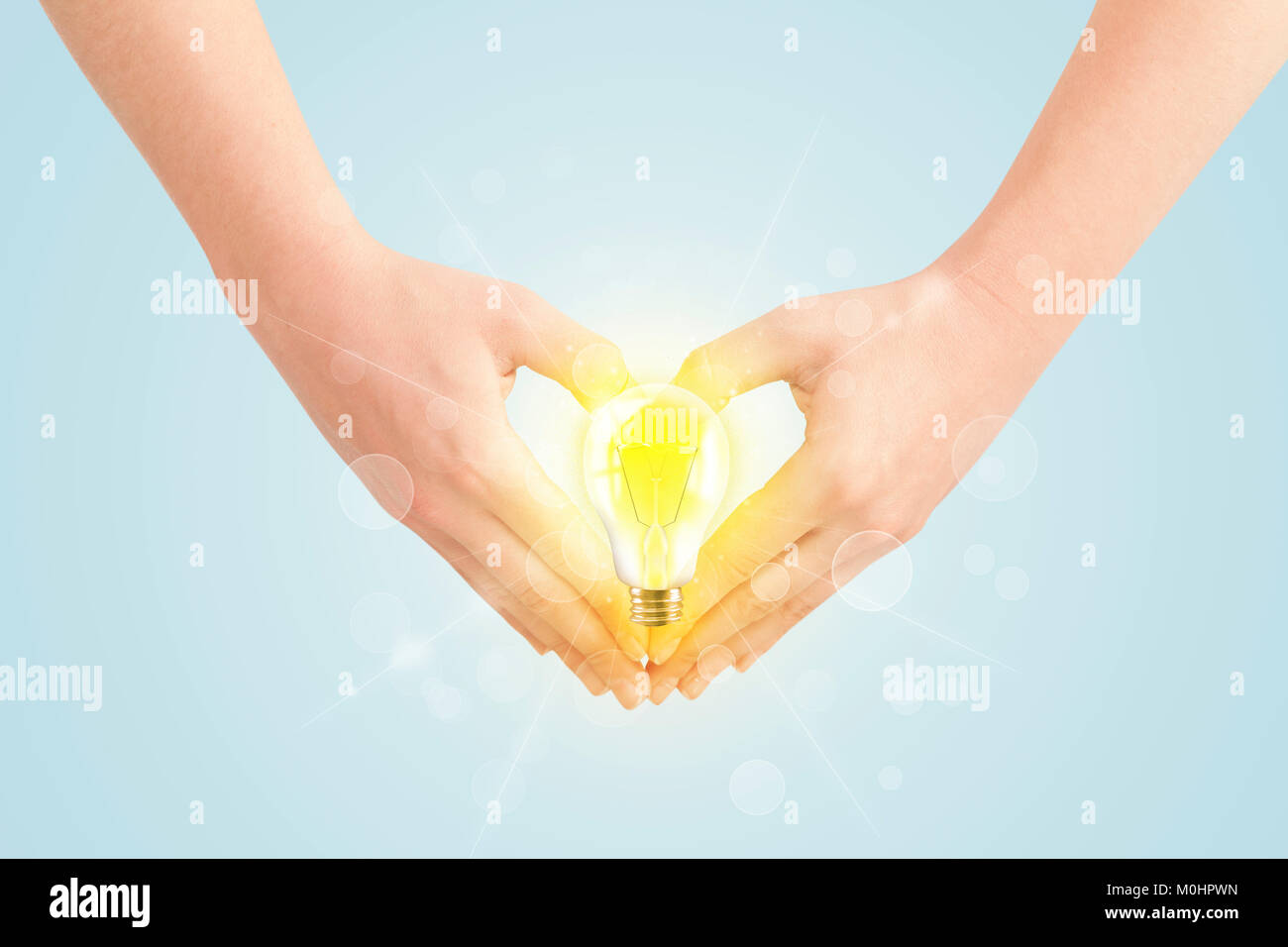 Hands creating a form with yellow light bulb in the center Stock Photo ...