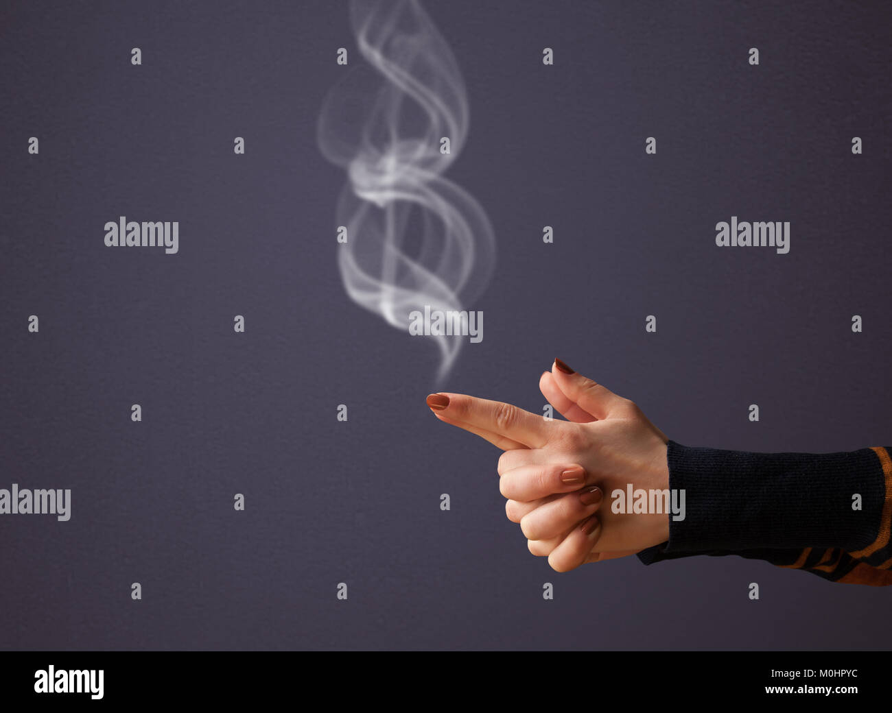 Gun shaped woman hand with smoke Stock Photo - Alamy