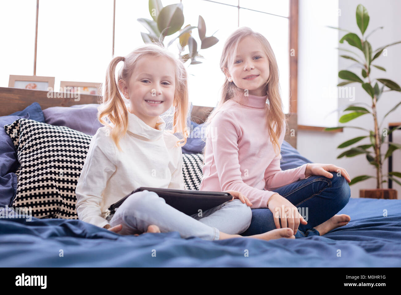Happy young girls playing together Stock Photo - Alamy