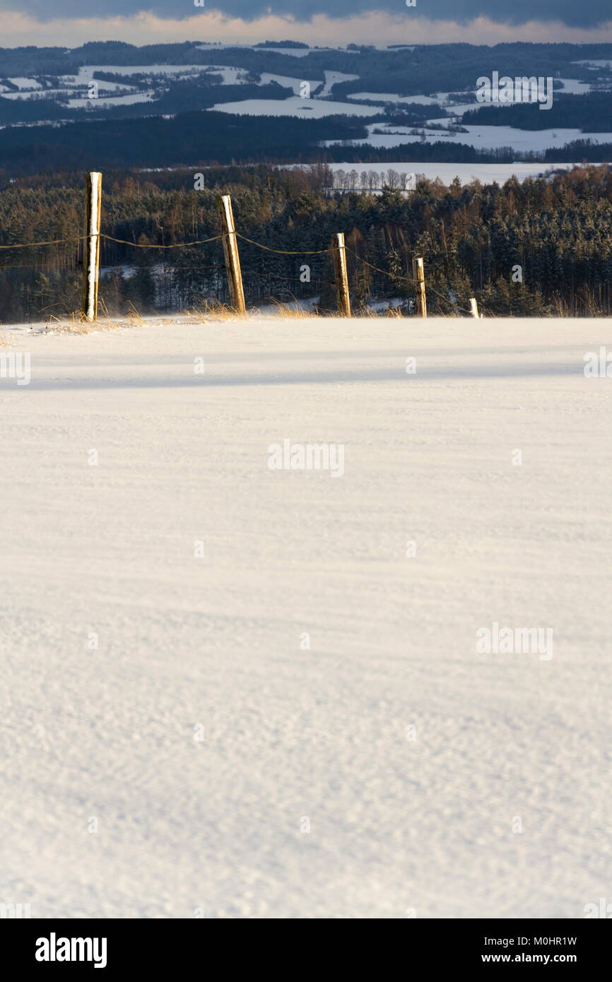 Fence poles in snowy winter country sunny day, weather forecast concept ...
