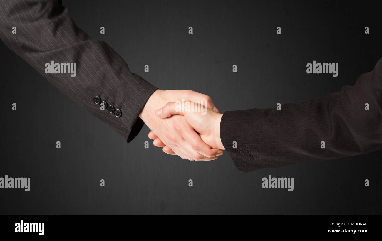 Business handshake on black background Stock Photo - Alamy